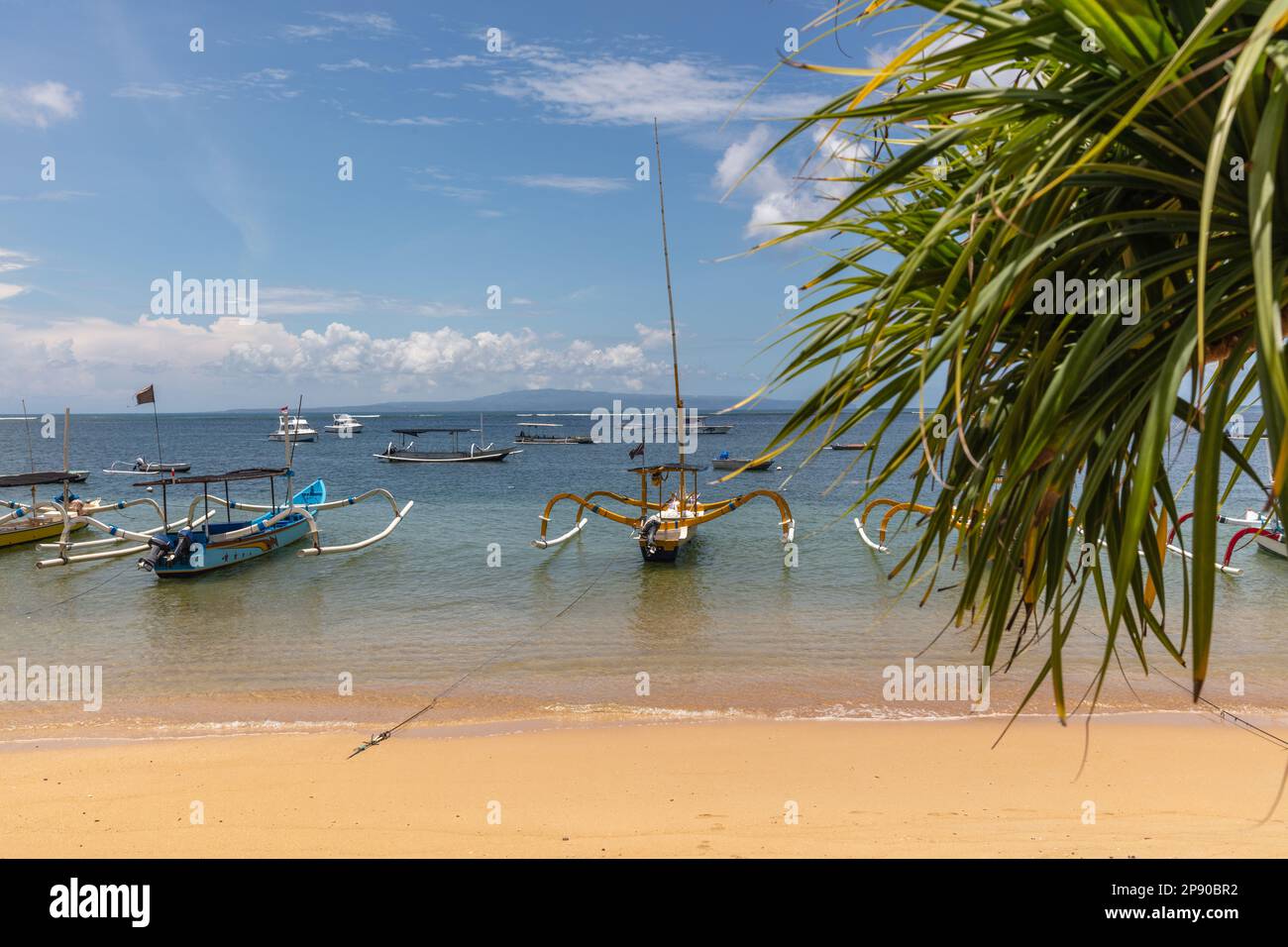 Traditional Indonesian outrigger style wooden fishing boats (jukung) on ...