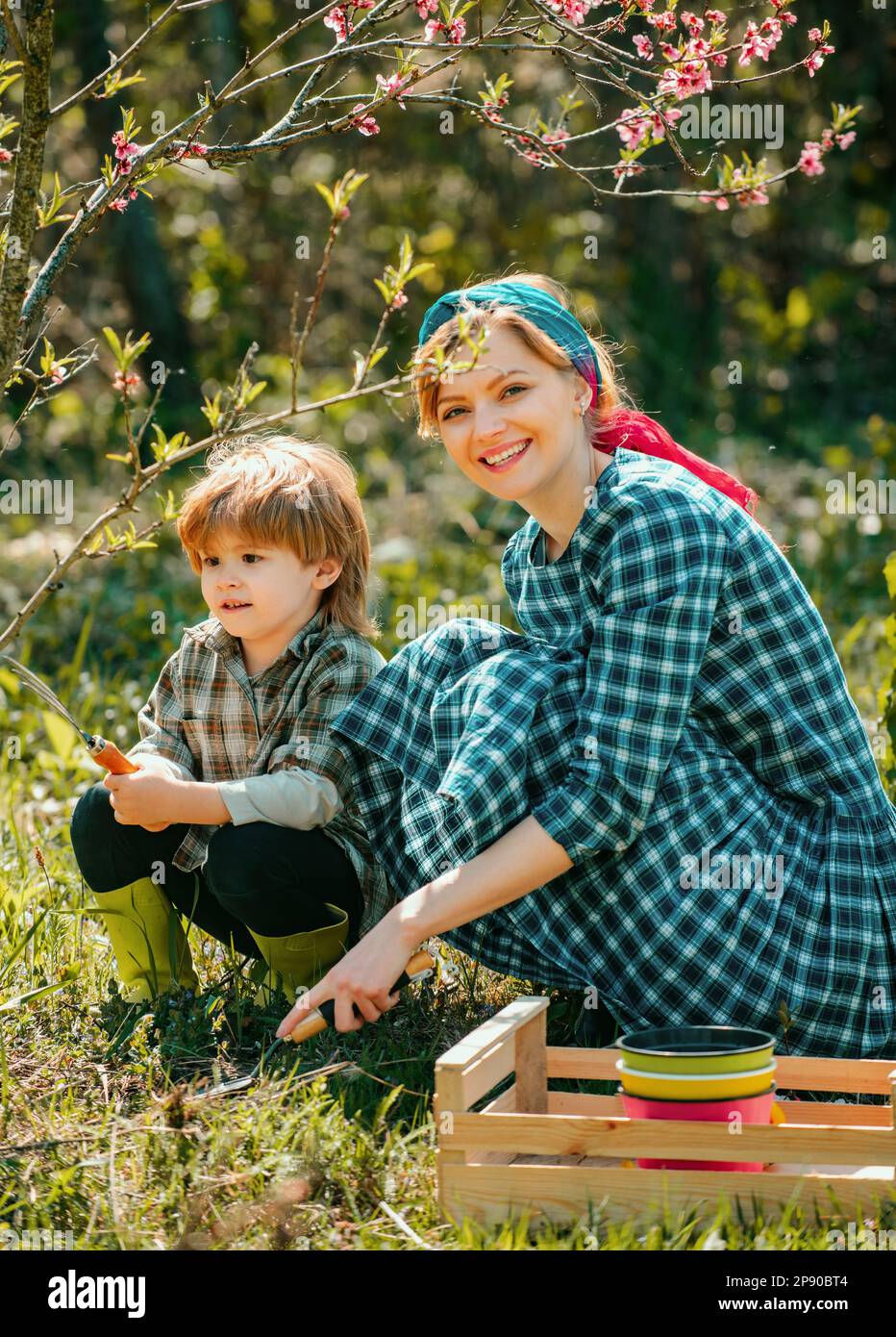 Mother and son farmers in the farm with countryside background. Eco ...