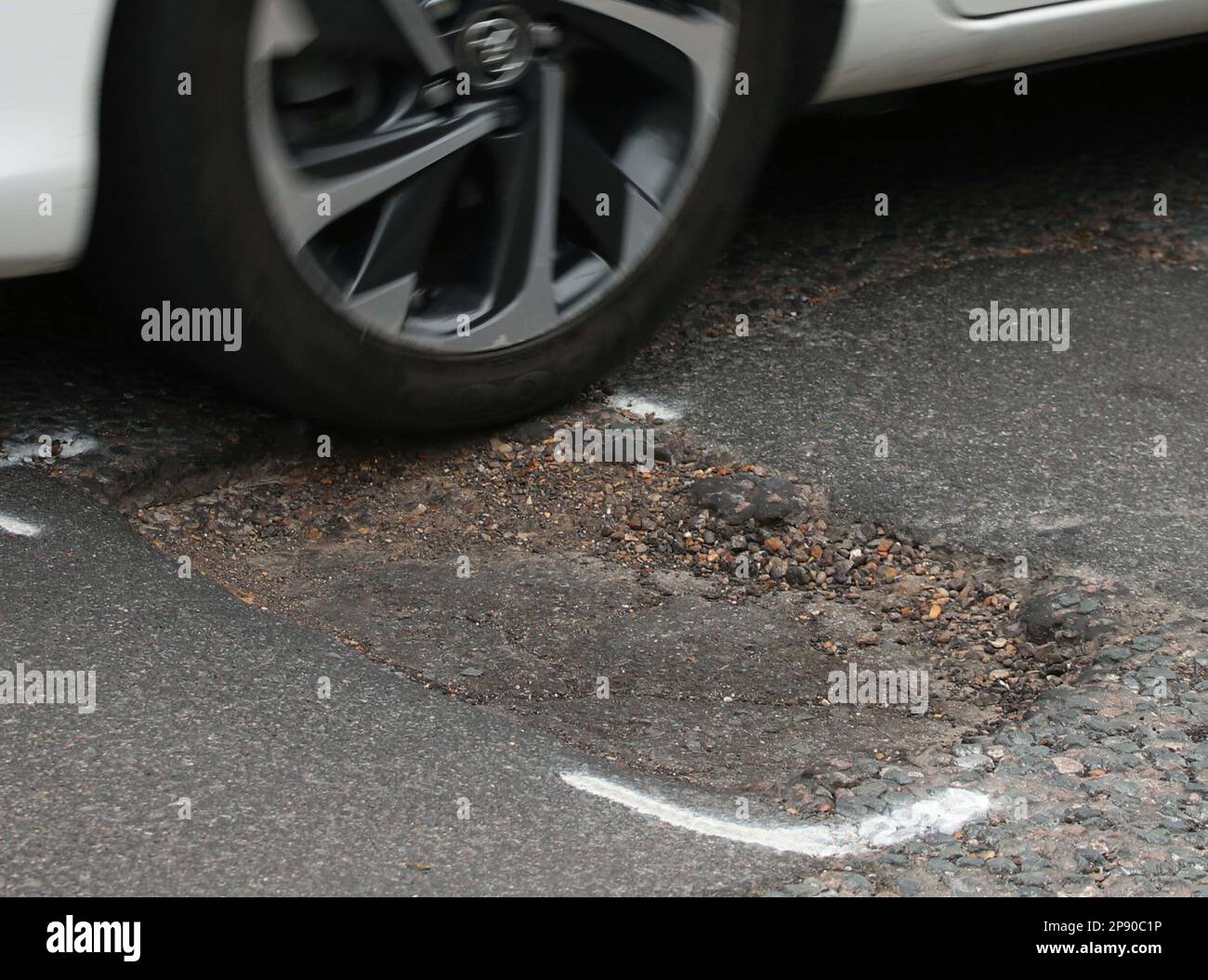 File photo dated 11/05/2018 of a car hitting a pothole on a road in ...