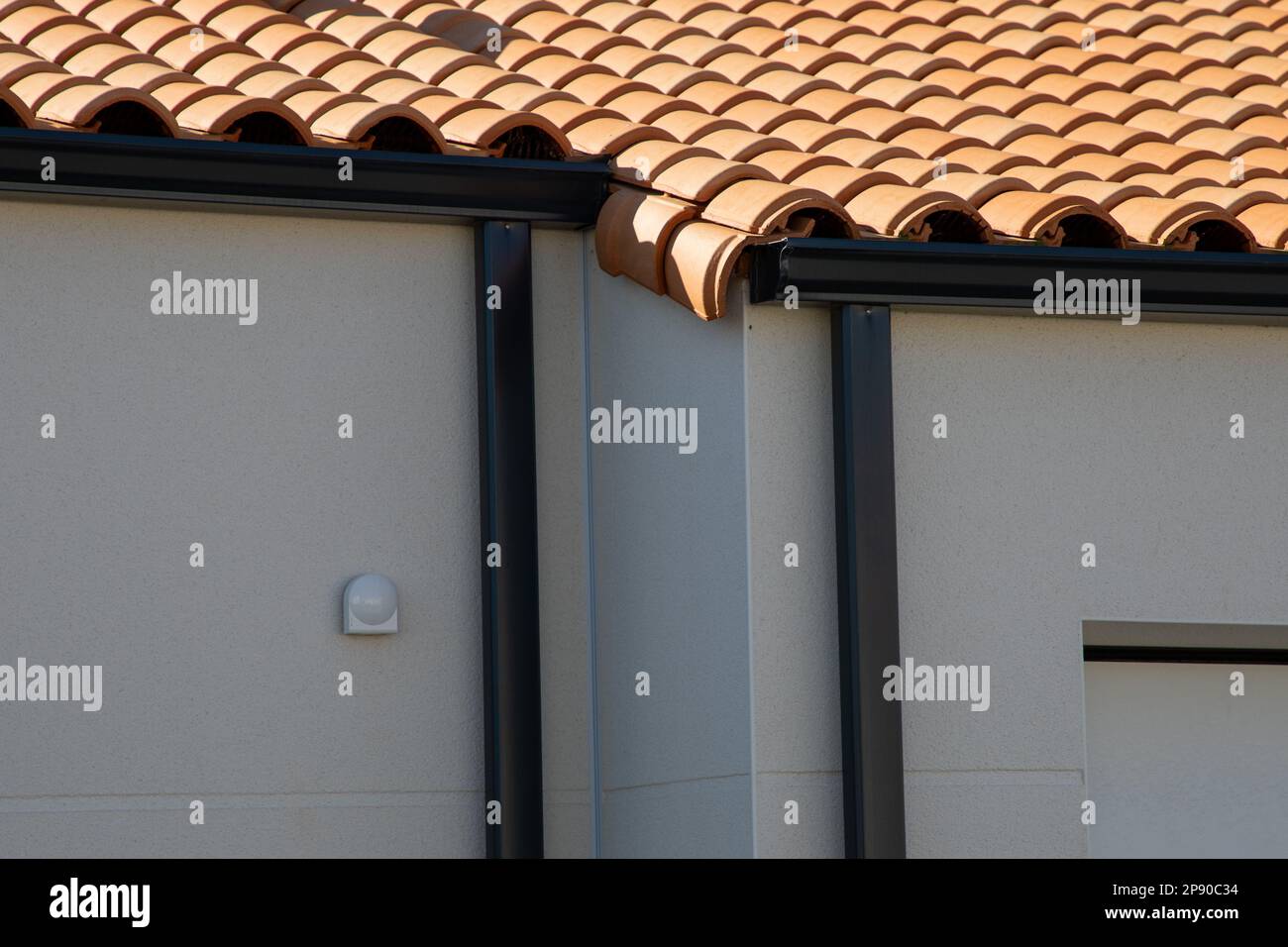 aluminum grey gutter on modern roof of the building and gray downpipe ...