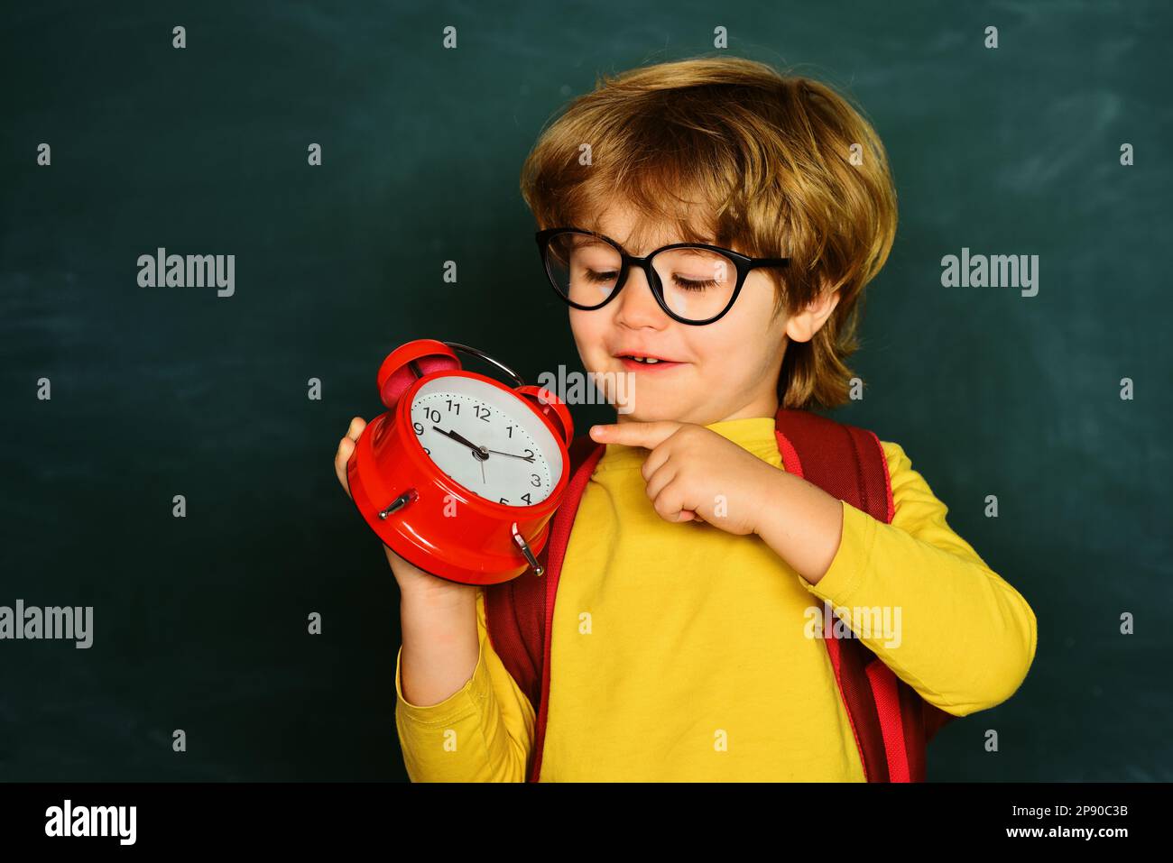 Back to school. Alarm clock anxiety. Late. Kid boy holding clock alarm ...