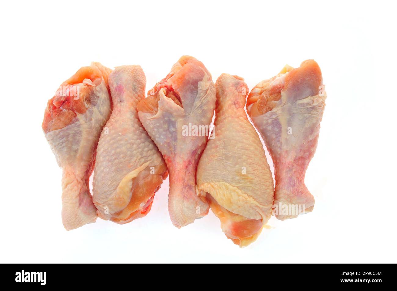 Raw chicken leg on a white background Stock Photo - Alamy