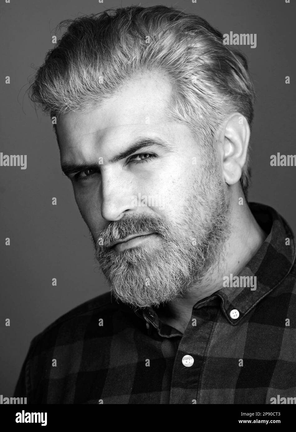 Serious man face. Close-up portrait of cheerful young man on gray ...