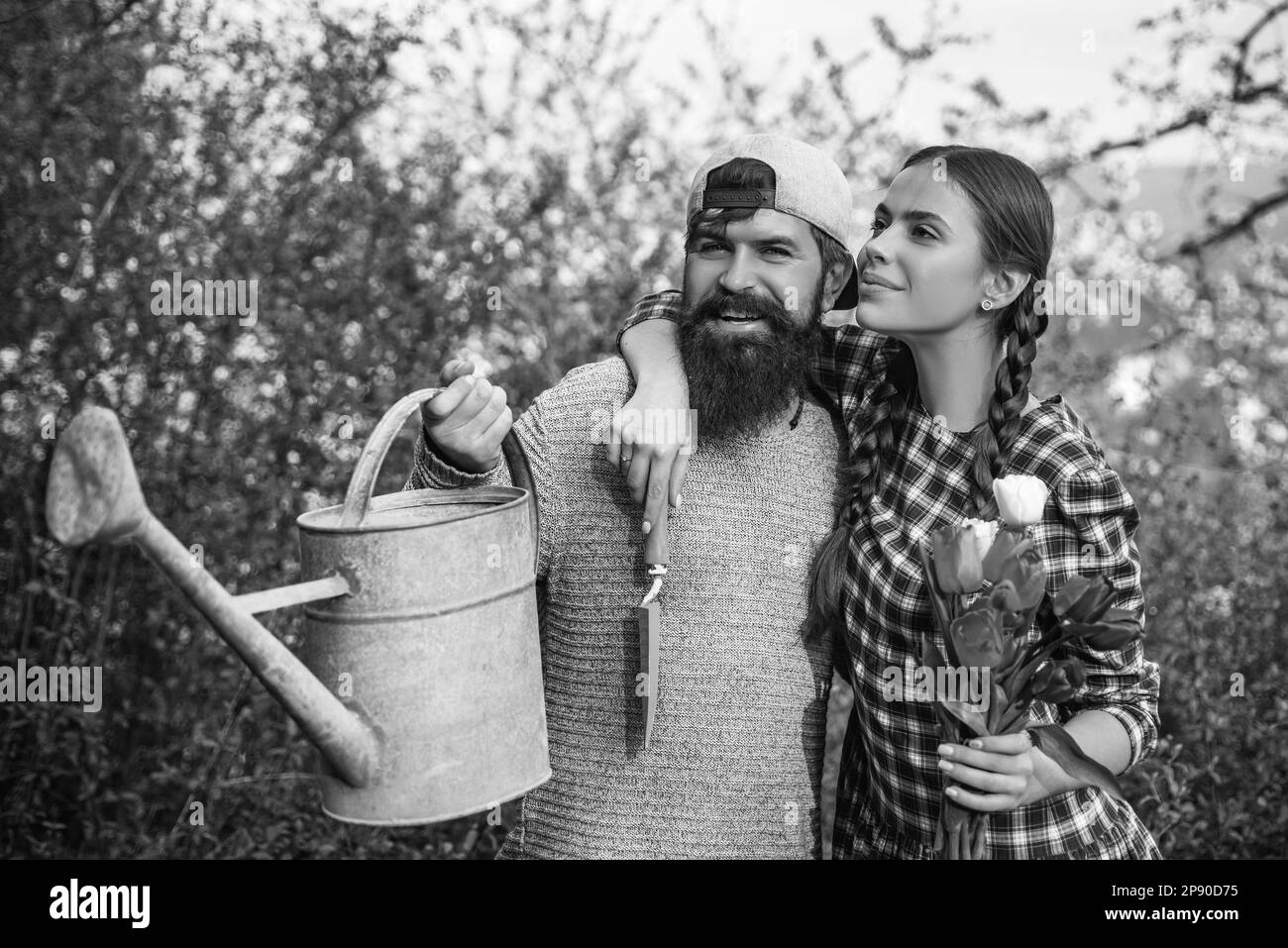 Lifestyle and family life. Two people gardening in the backyard garden ...