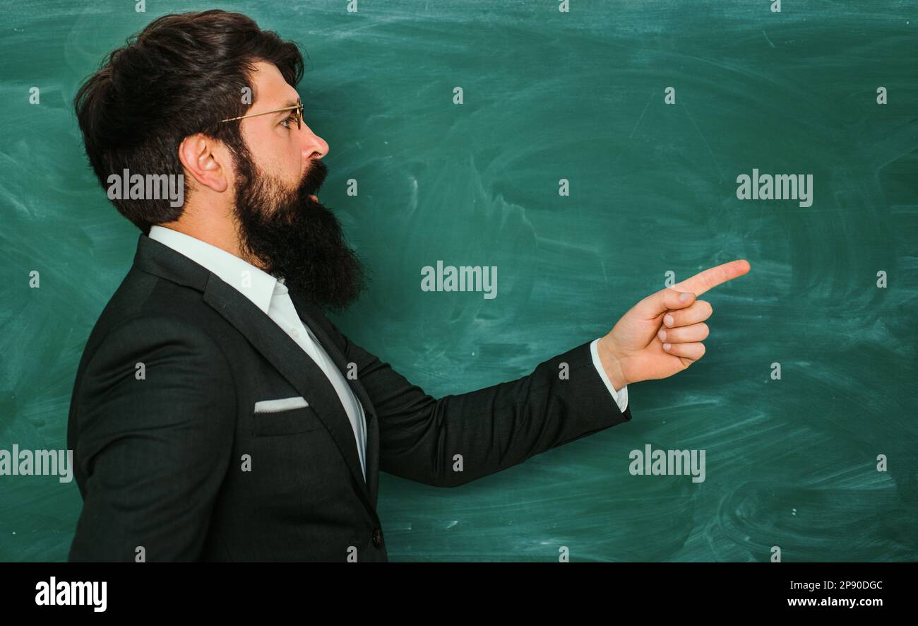 Bearded professor at school lesson at desks in classroom. Education ...