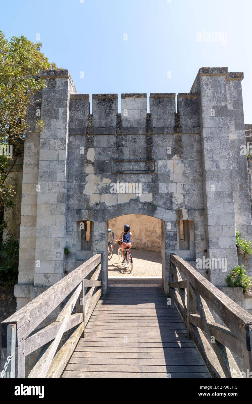 tourist in La Rochelle Ramparts gate with wooden path bridge in France ...