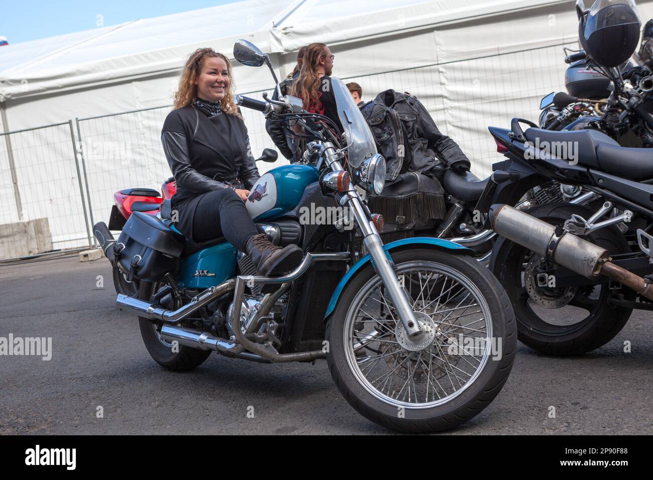 Saint-Petersburg, Russia-circa Aug, 2018: Happy girl motorcyclist sits ...