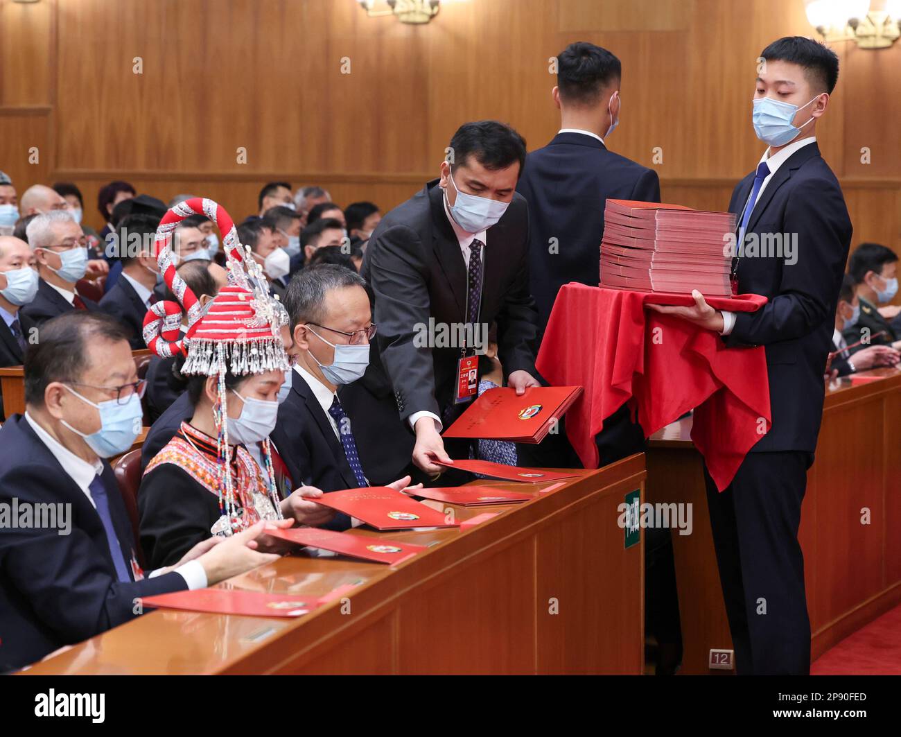 Beijing, China. 10th Mar, 2023. Staff members distribute ballots at the ...
