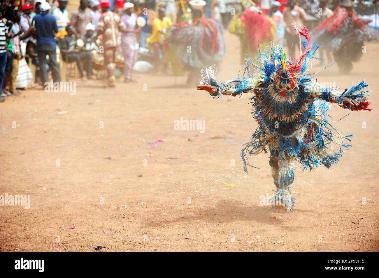 A masked figure performing Festima Festival in Dedougou, Burkina Faso ...