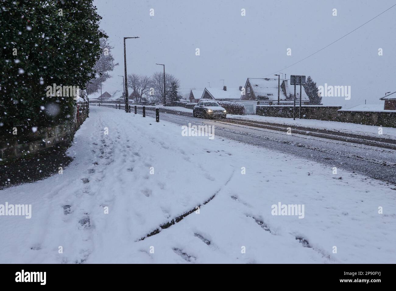 Barnsley, UK. 10th Mar, 2023. A car makes its way into town as heavy ...