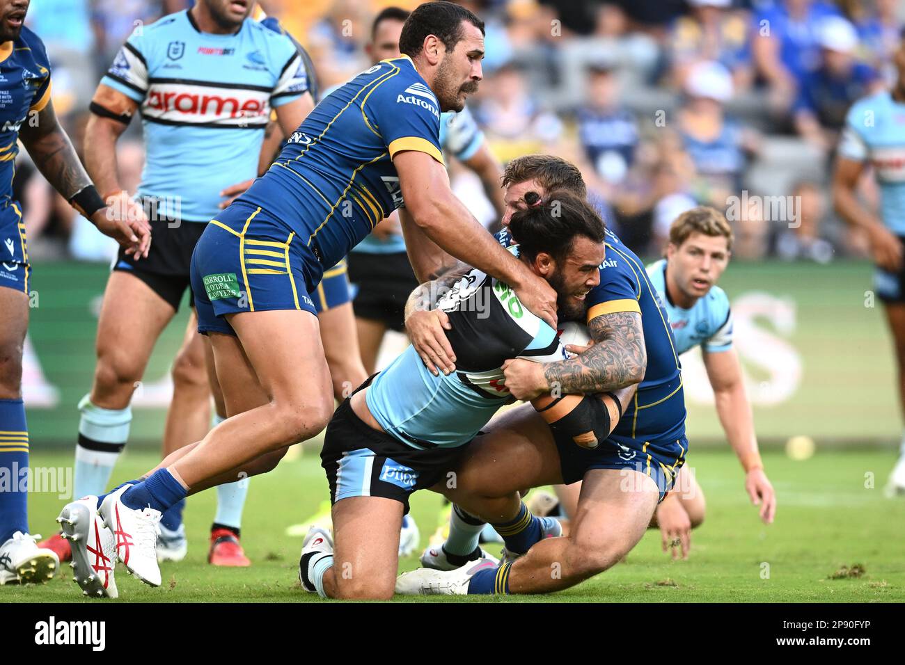 Toby Rudolf of the Sharks is tackled by Reagan Campbell-Gillard (left ...