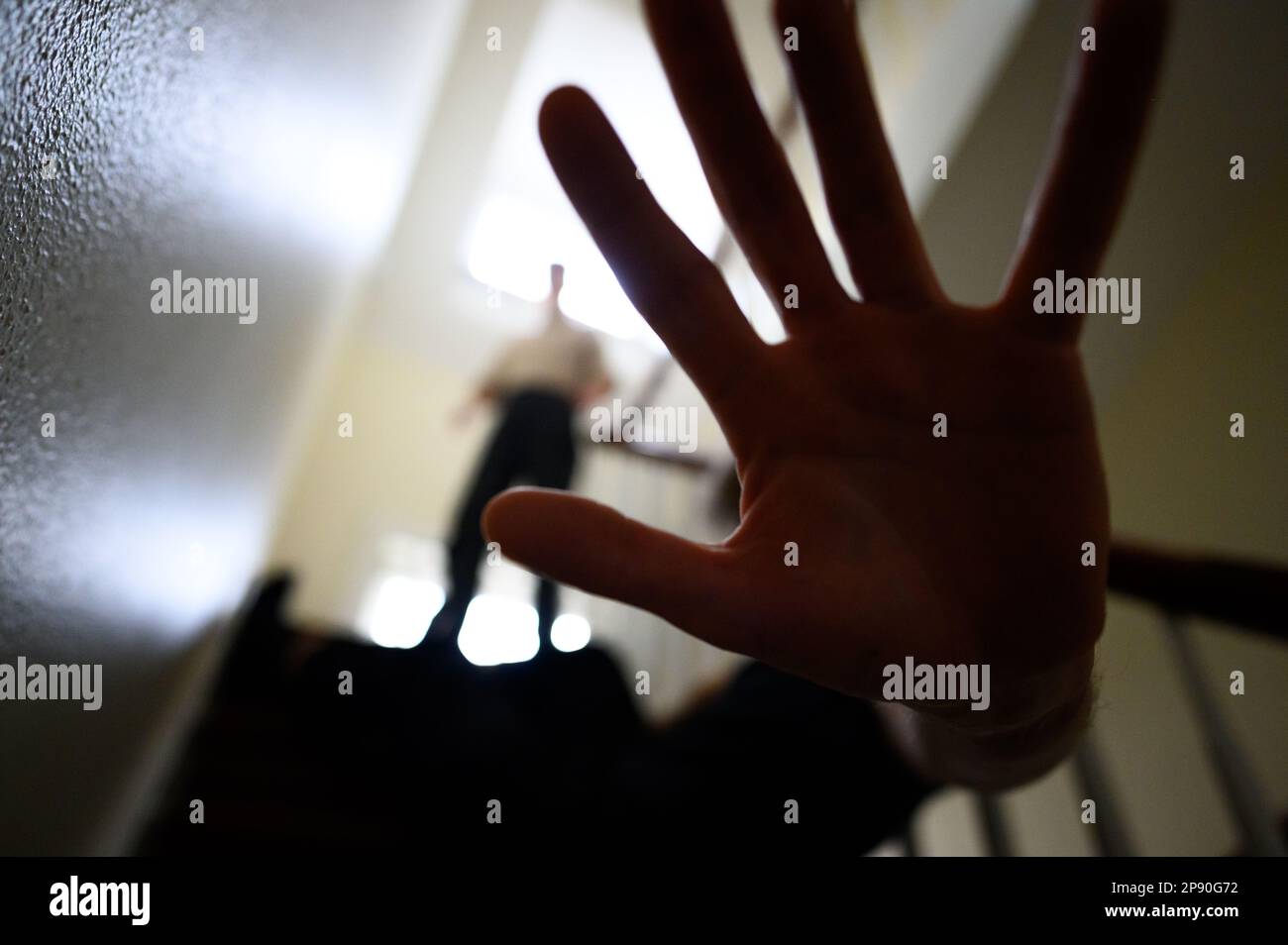 Hamburg, Germany. 12th Feb, 2023. A man sits in the stairwell and makes ...