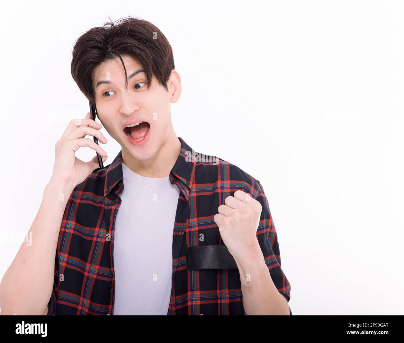 Excited young man talking on the phone and showing yes gesture Stock ...