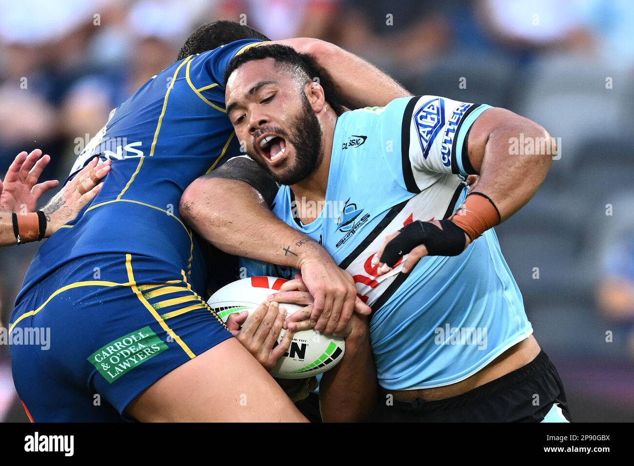 Siosifa Talakai of the Sharks is tackled by Reagan Campbell-Gillard of ...