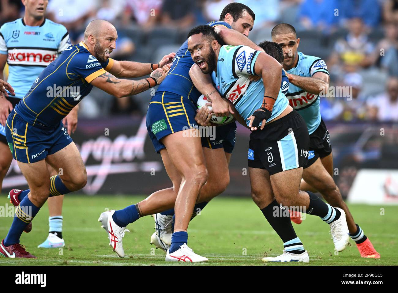 Siosifa Talakai of the Sharks is tackled by Reagan Campbell-Gillard of ...