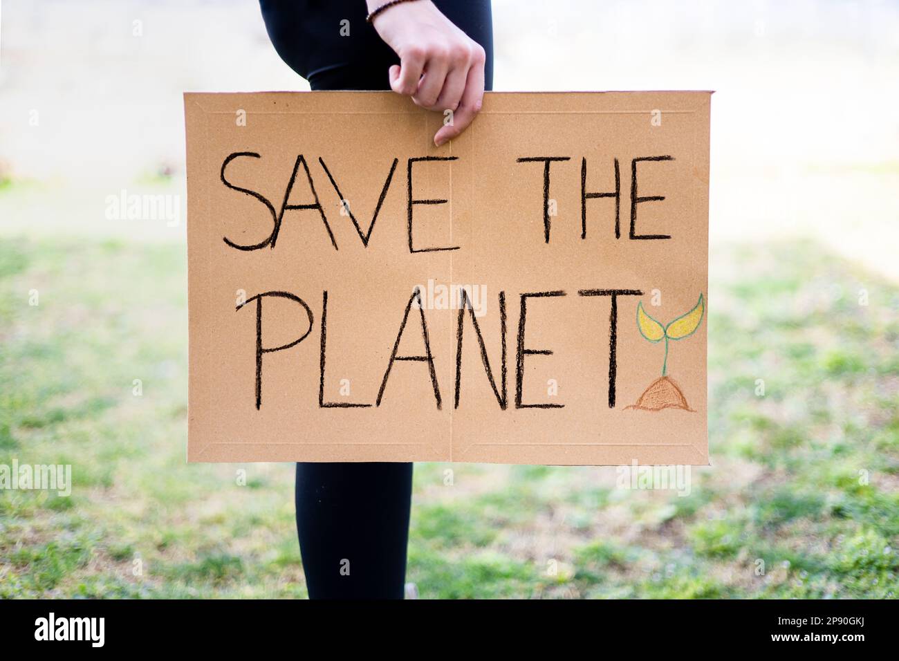 Activist woman holding "SAVE THE PLANET" poster for manifestation ...