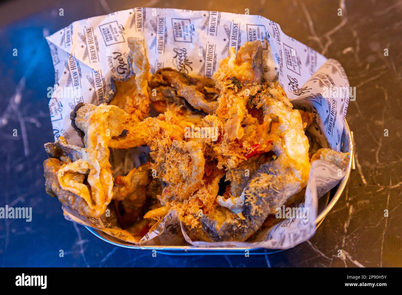 Fried salted fish skin in a bowl Stock Photo - Alamy