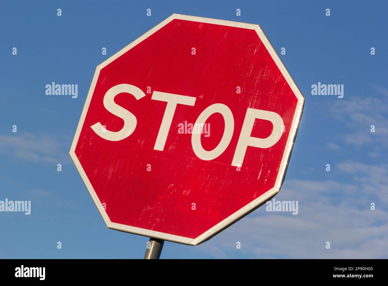Red Stop Sign with Blue Sky and Clouds Background Stock Photo - Alamy