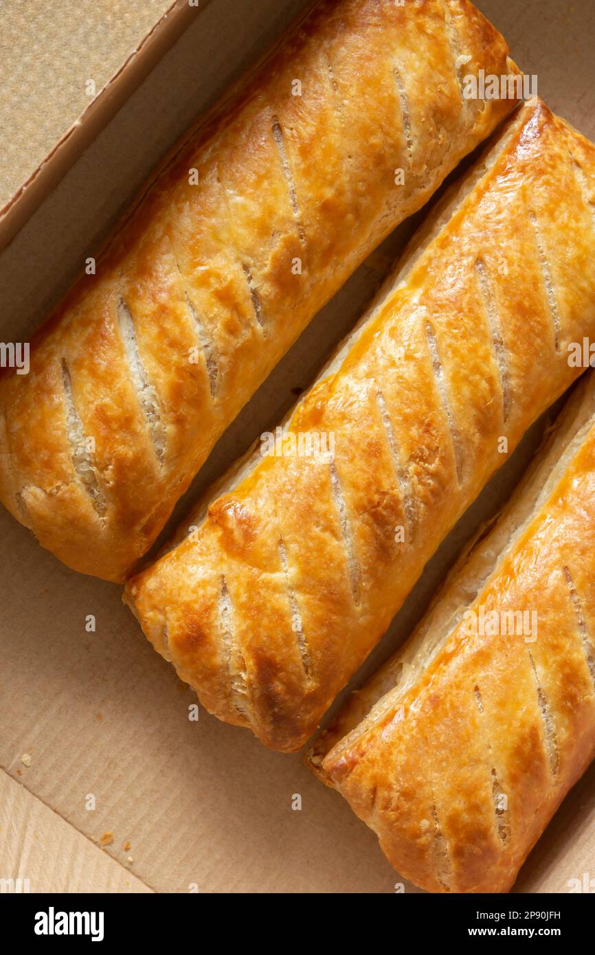 Sausage rolls in a cardboard takeaway tray. Sustainable biodegradable ...