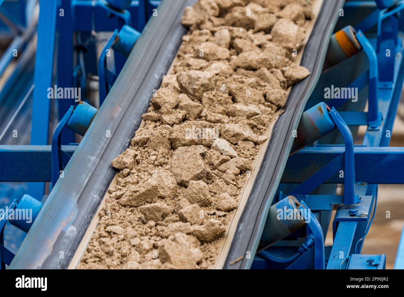 Industrial belt conveyor moving raw materials from mine Stock Photo - Alamy