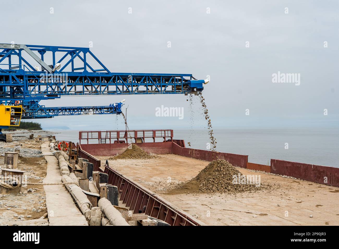 Industrial belt conveyor moving raw materials from mine Stock Photo - Alamy