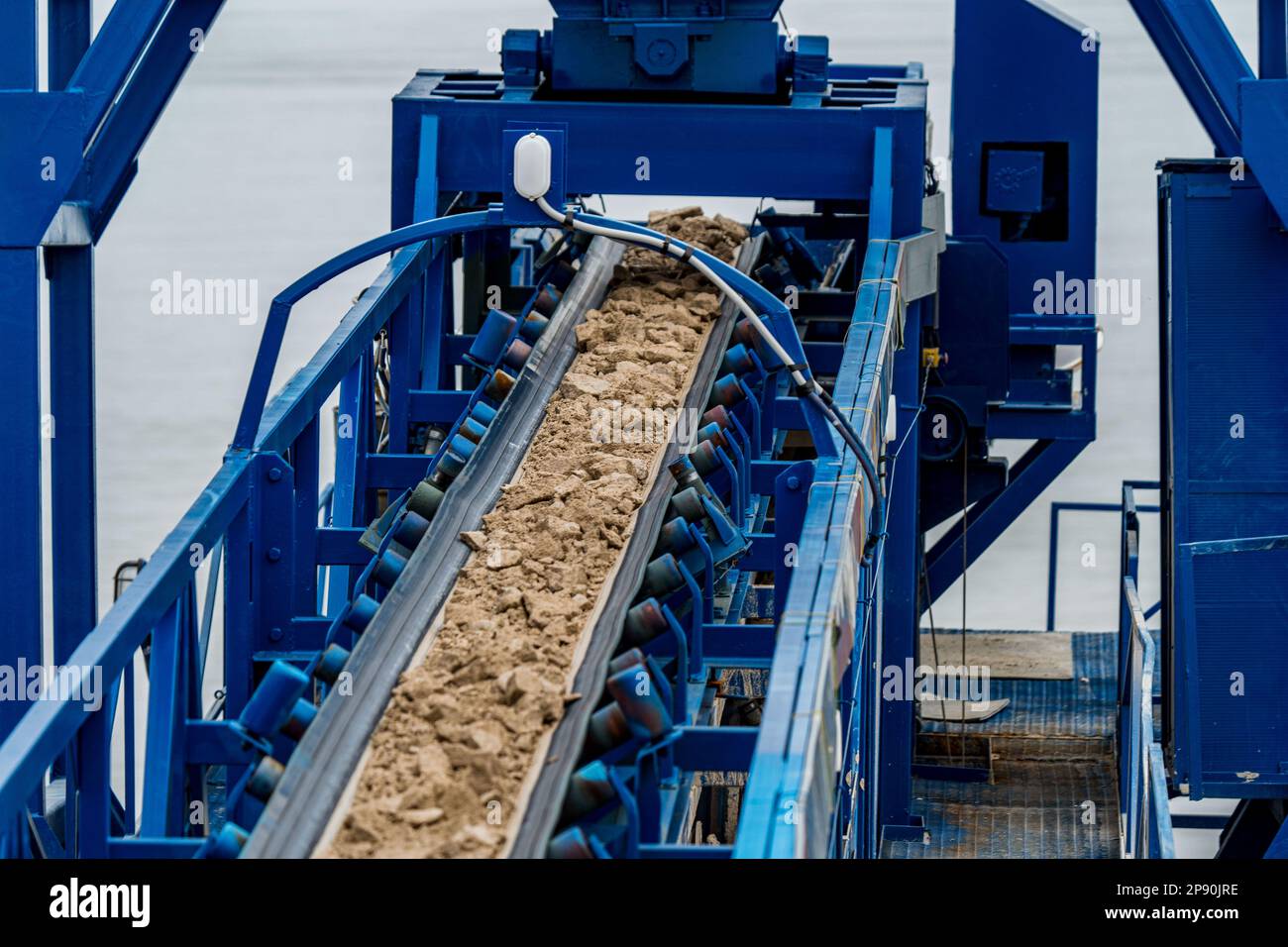 Industrial belt conveyor moving raw materials from mine Stock Photo - Alamy