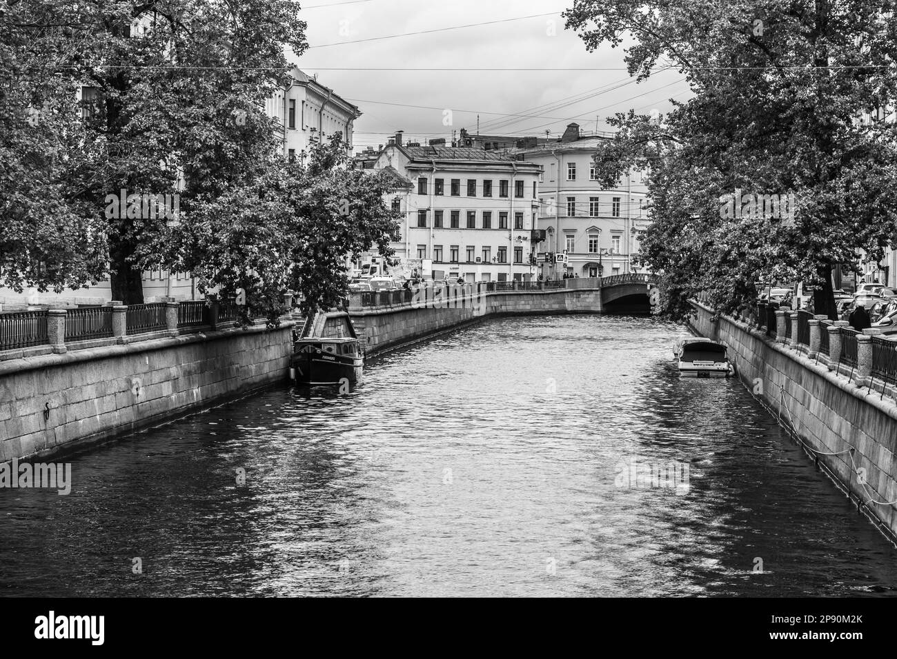 People walk along the embankment of the Moika River in St. Petersburg ...