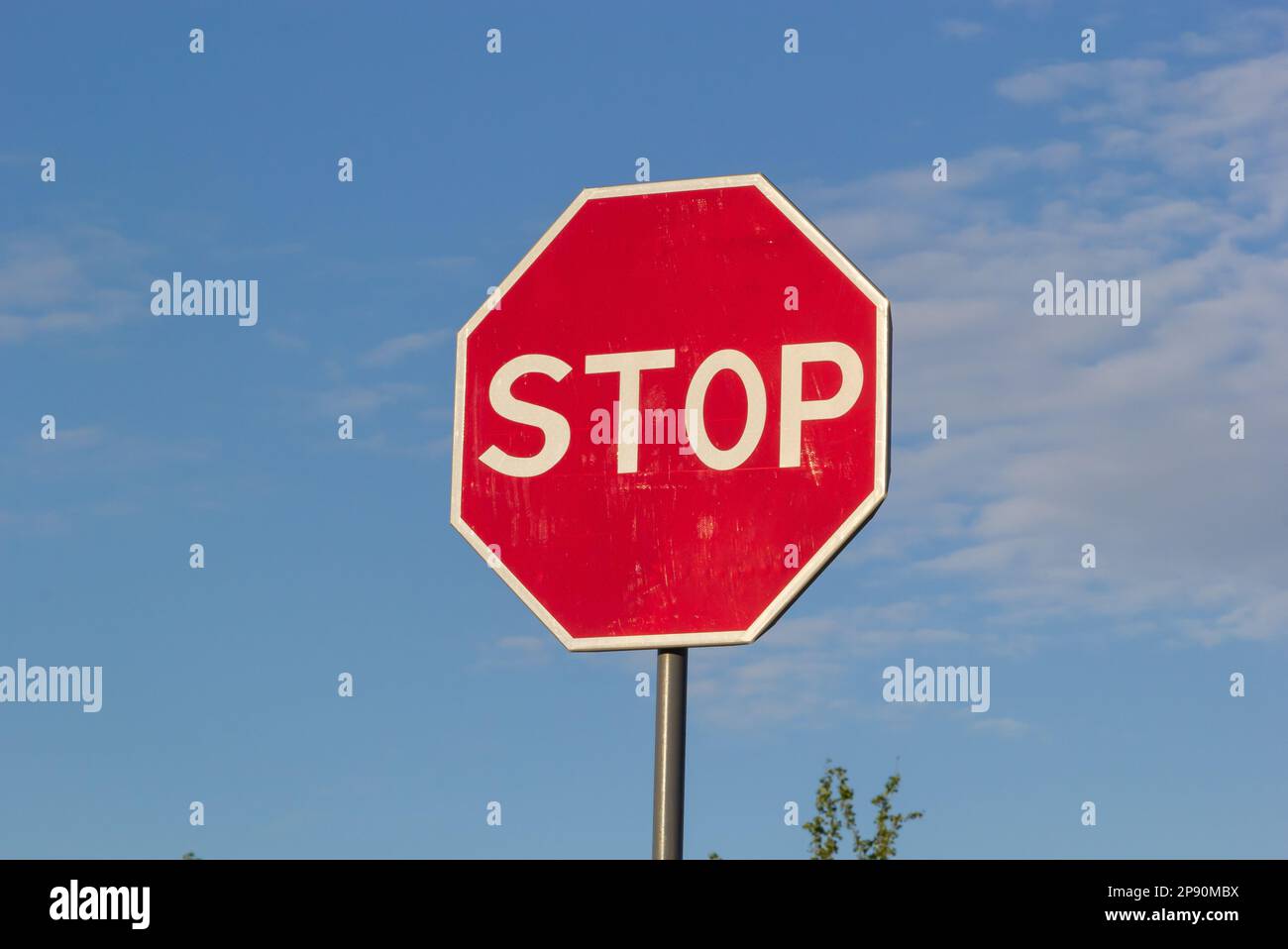 Red Stop Sign with Blue Sky and Clouds Background Stock Photo - Alamy