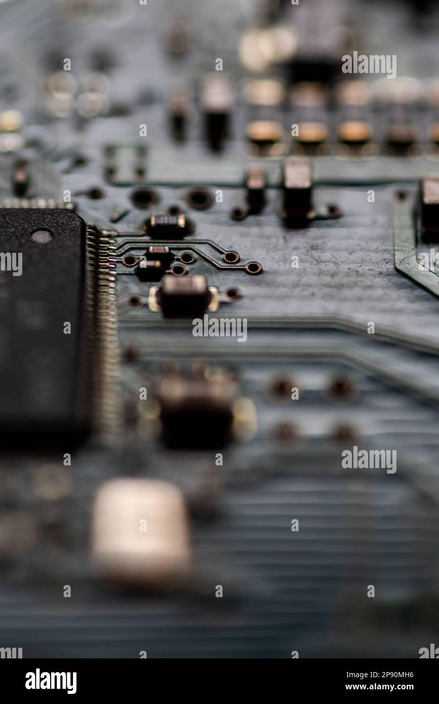 closeup of a circuit board from a hard drive with transistors and ...