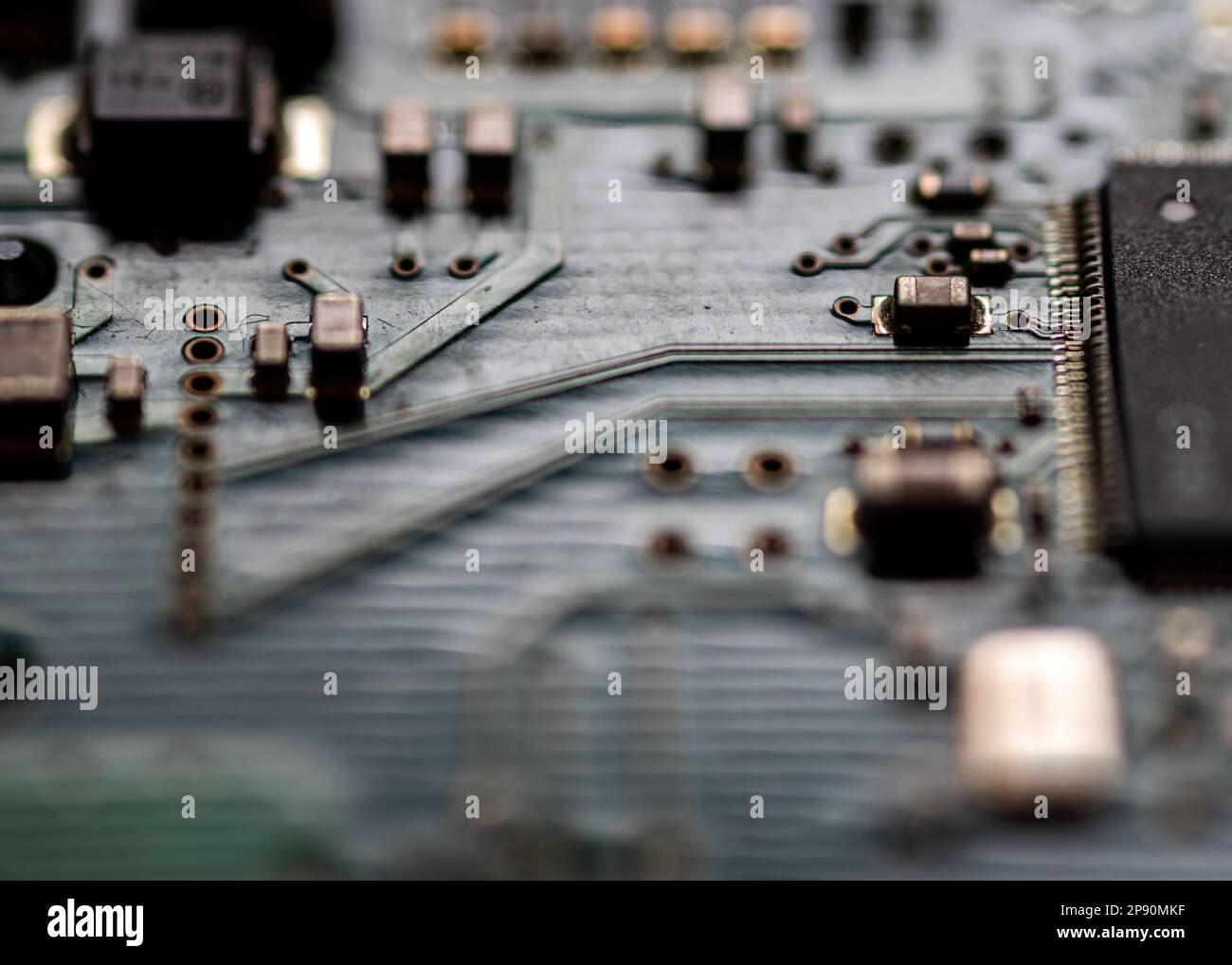 closeup of a circuit board from a hard drive with transistors and ...
