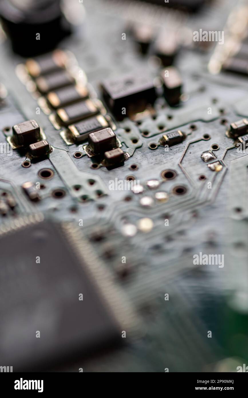 closeup of a circuit board from a hard drive with transistors and ...