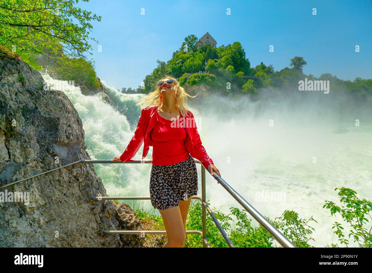 Woman at panorama of the Swiss waterfall Rhine Falls in Switzerland ...