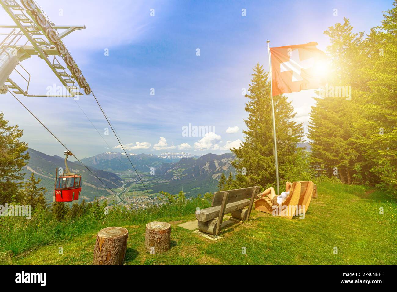 Girl at sunset in Switzerland with Swiss flag and cable car of ...