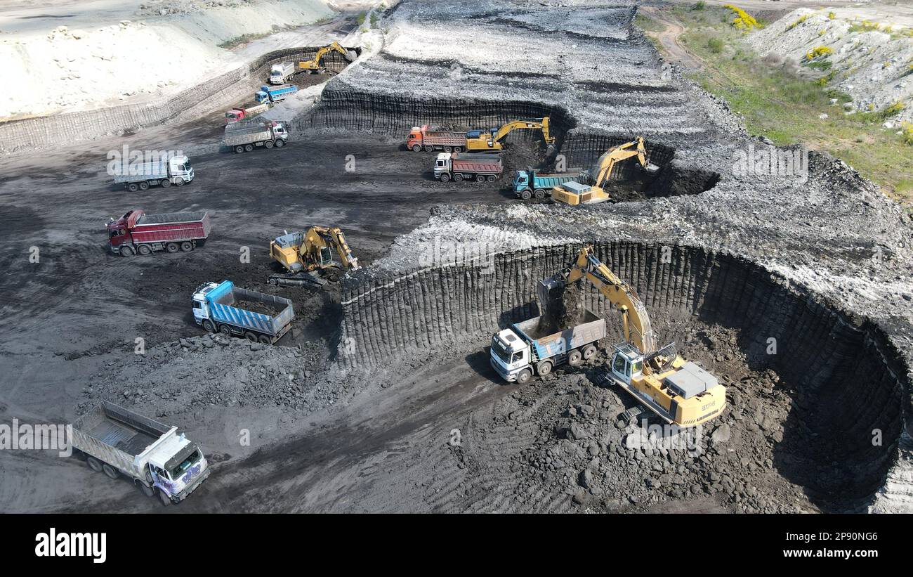 Excavators Working On Huge Mining Site, Loading The Trucks, Trucks ...