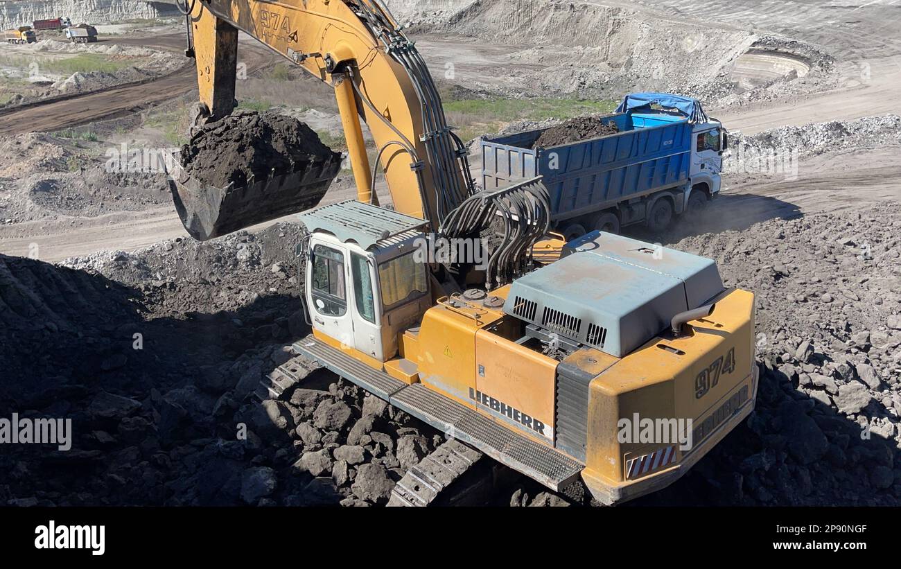 Excavator Working On Huge Mining Site, Loading The Trucks, Trucks ...