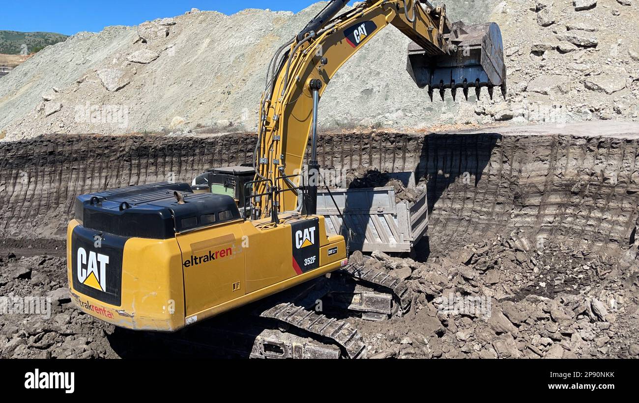 Excavator Working On Huge Mining Site, Loading The Trucks, Trucks ...