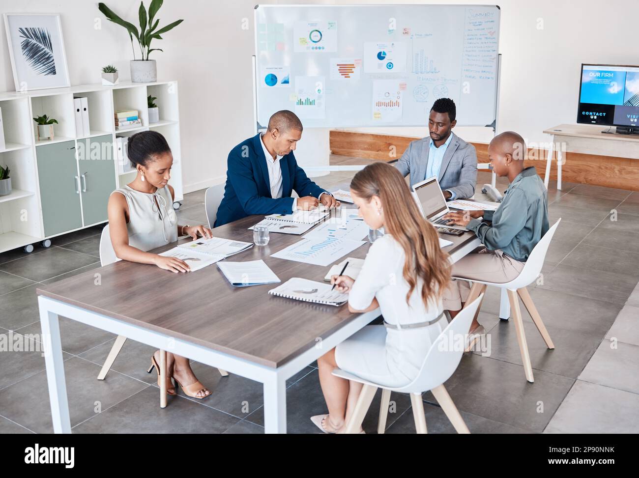Business people working on documents and laptop at a office boardroom ...