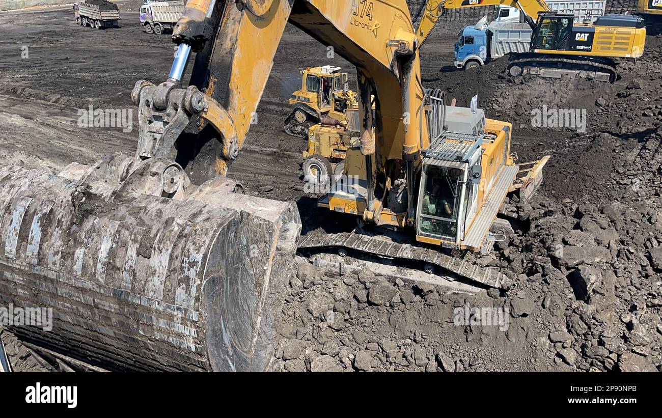 Excavators Working On Huge Mining Site, Loading The Trucks, Trucks ...
