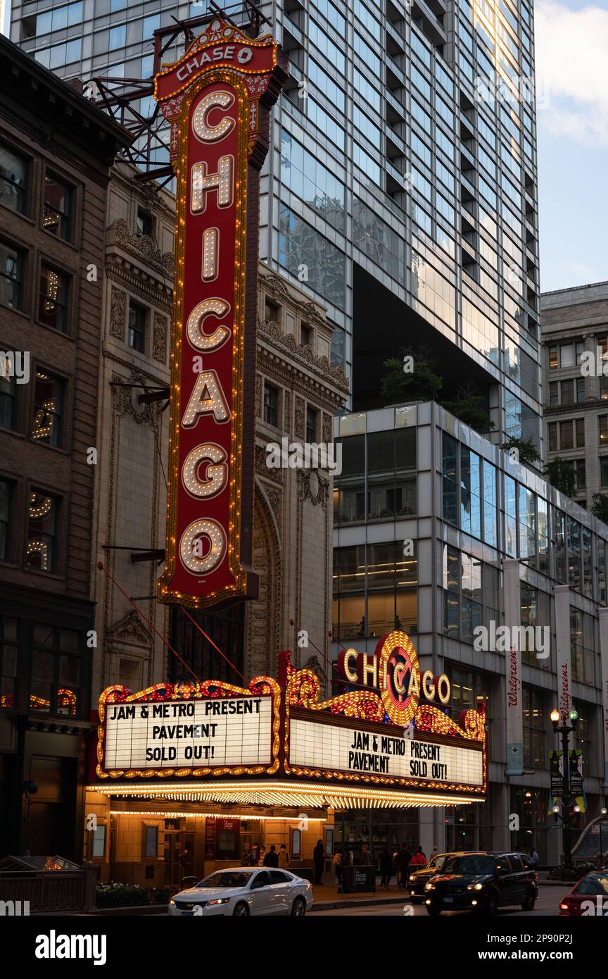 A vertical shot of the Chicago theater neon sign from a bustling street ...
