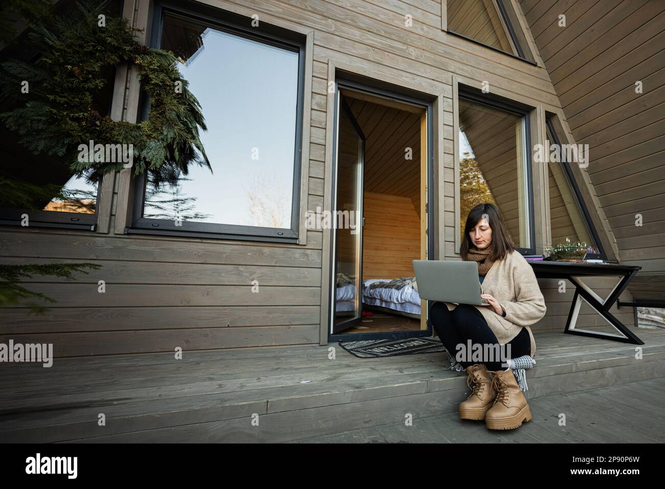 Remote work and escaping to nature concept. Woman works on laptop ...