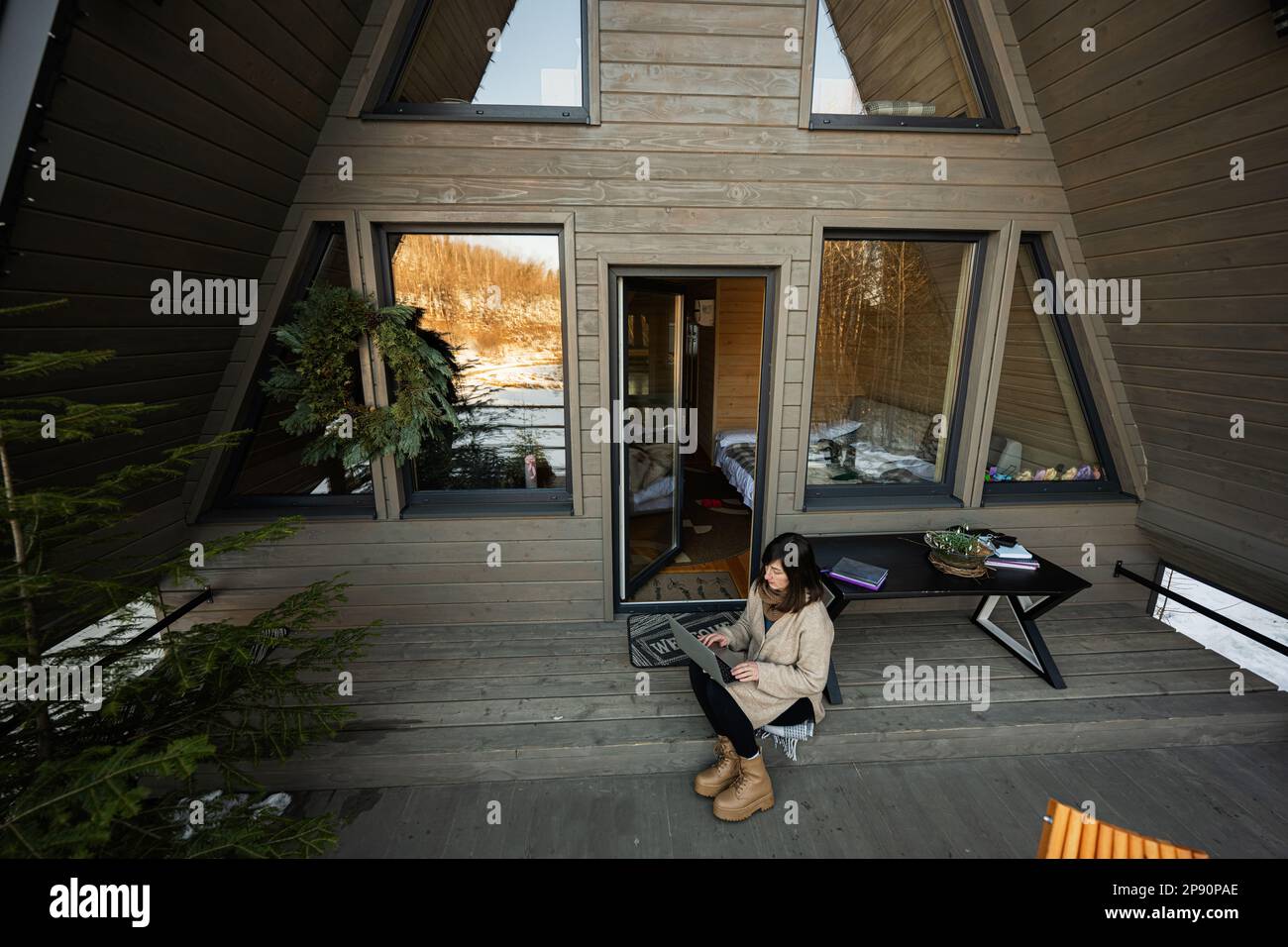 Remote work and escaping to nature concept. Woman works on laptop ...