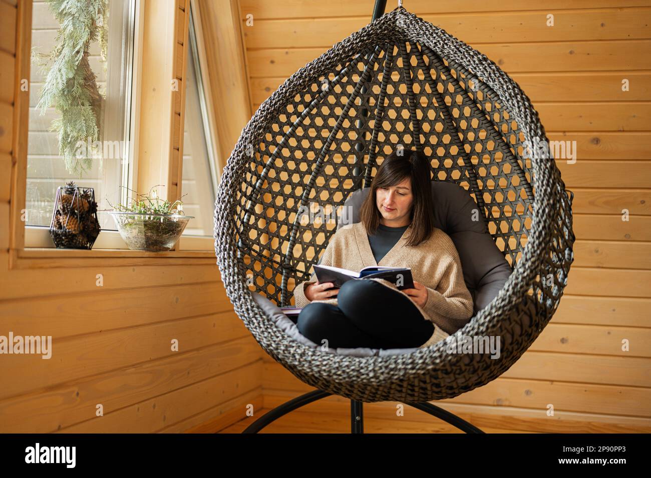 Remote work and escaping to nature concept. Woman sit in egg chair ...
