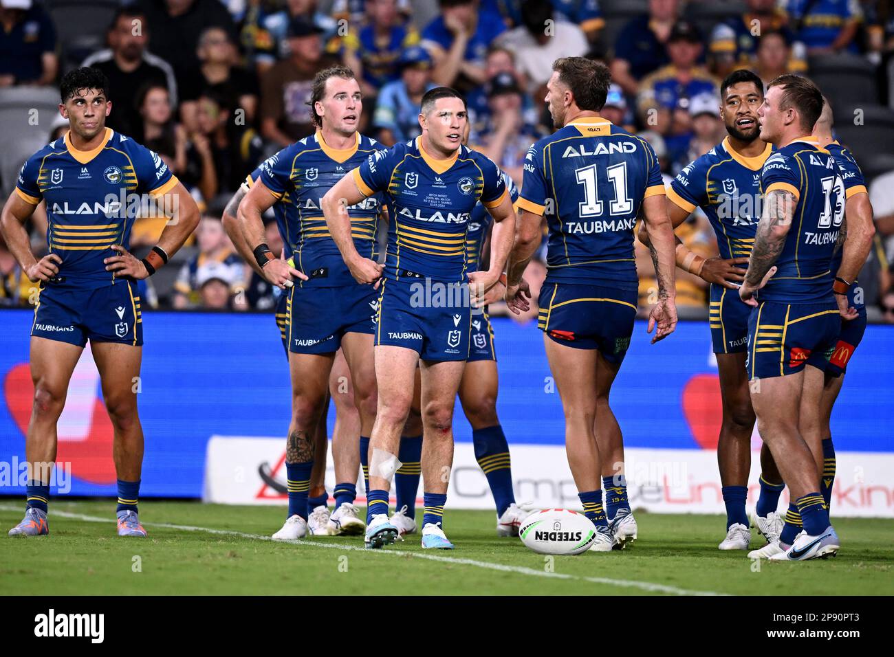Clint Gutherson and Mitchell Moses of the Eels (centre) and teamates ...