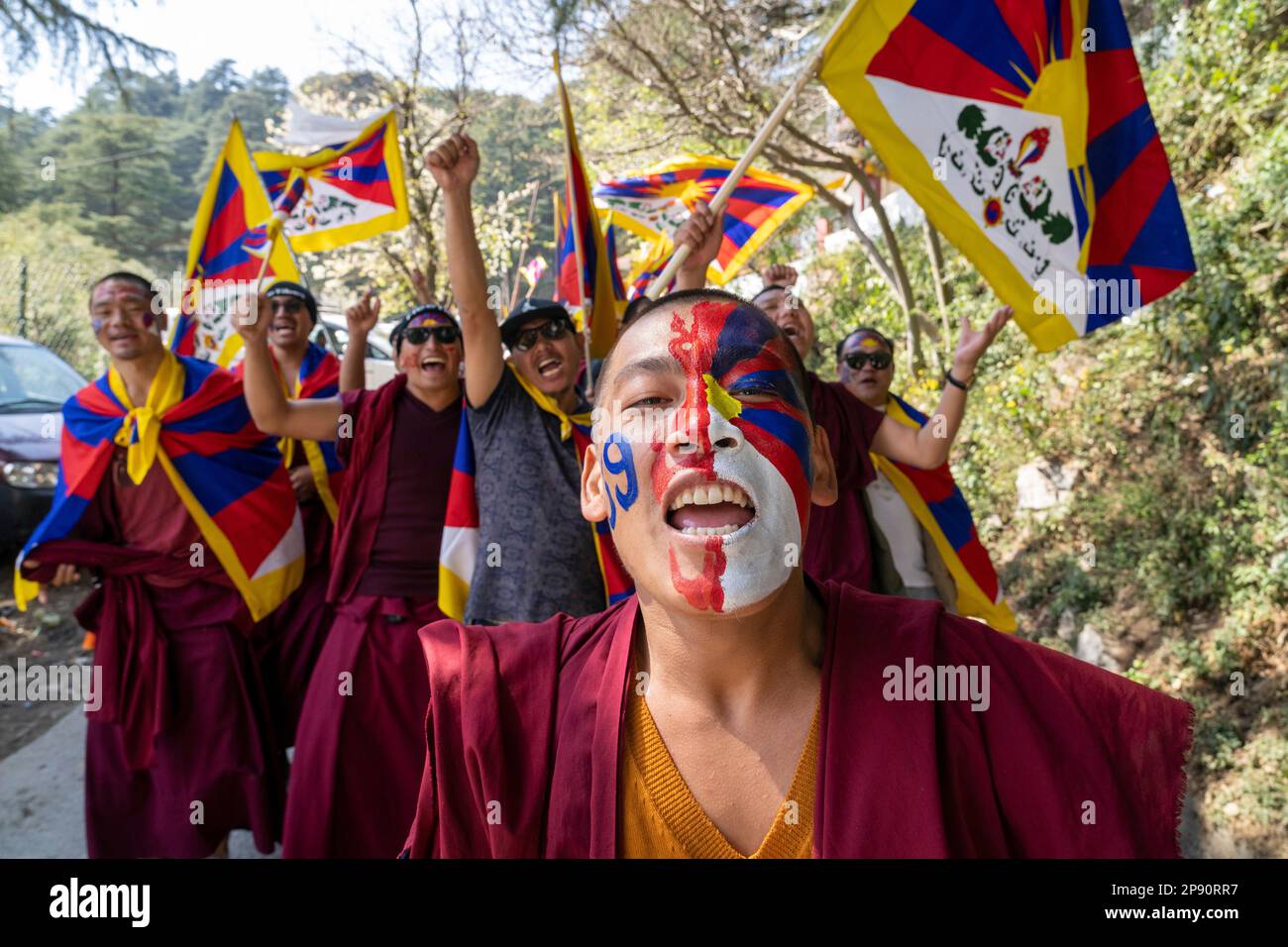 Exile Tibetan Buddhist monks shout slogans during a protest march to ...