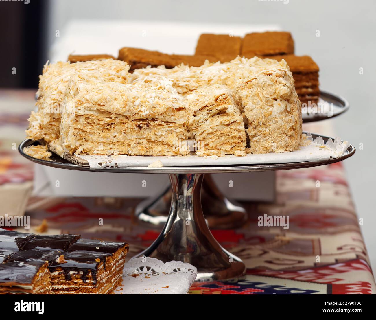 Layered puff pastry cake on display at the patisserie stand at the ...