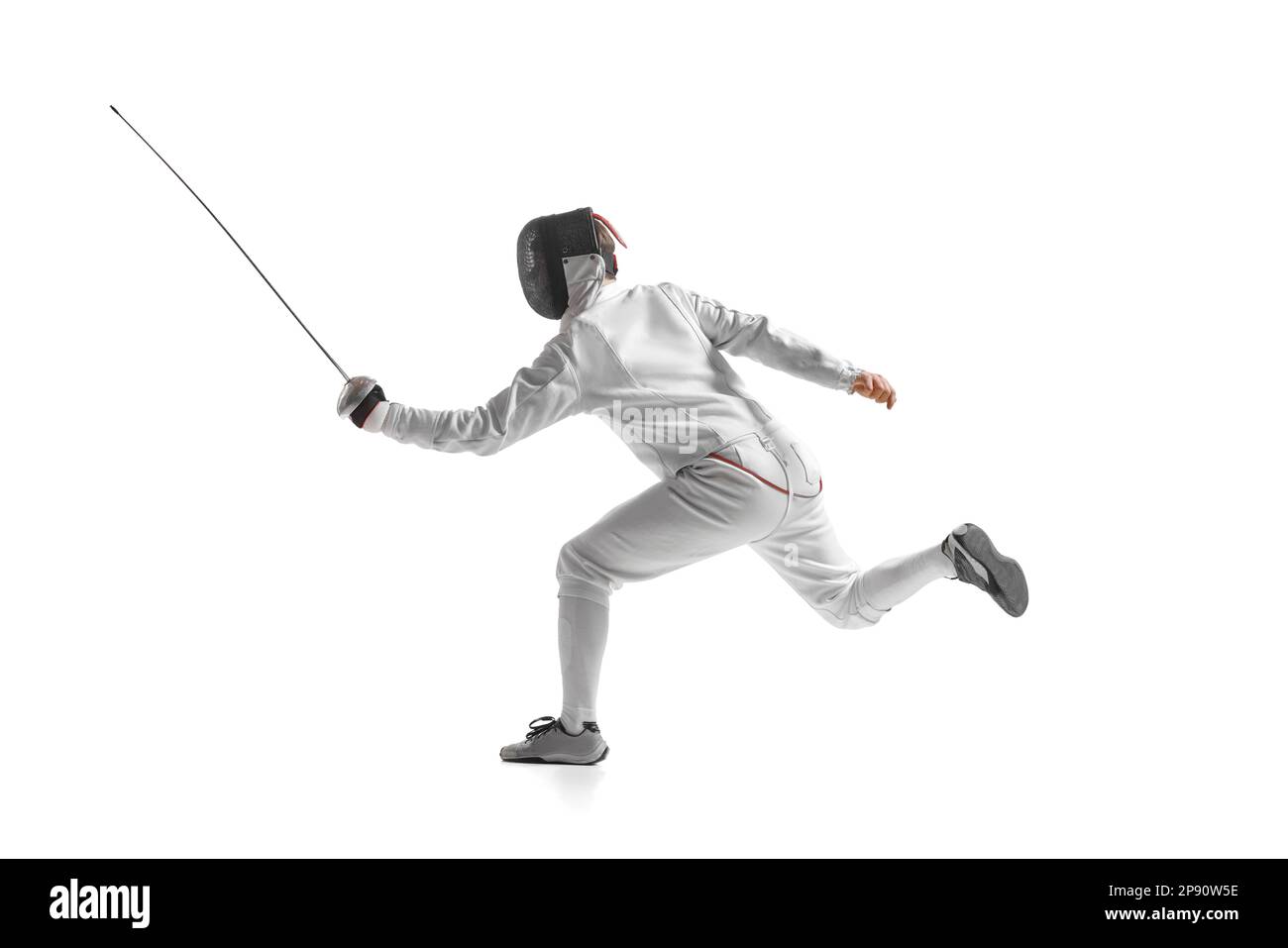 Dynamic portrait of male athlete in fencing costume with sword in hand ...