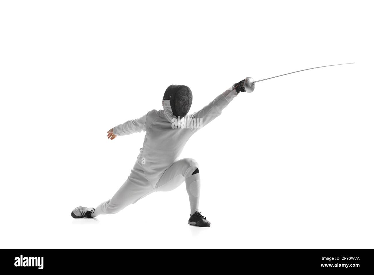 Dynamic portrait of male athlete in fencing costume with sword in hand ...