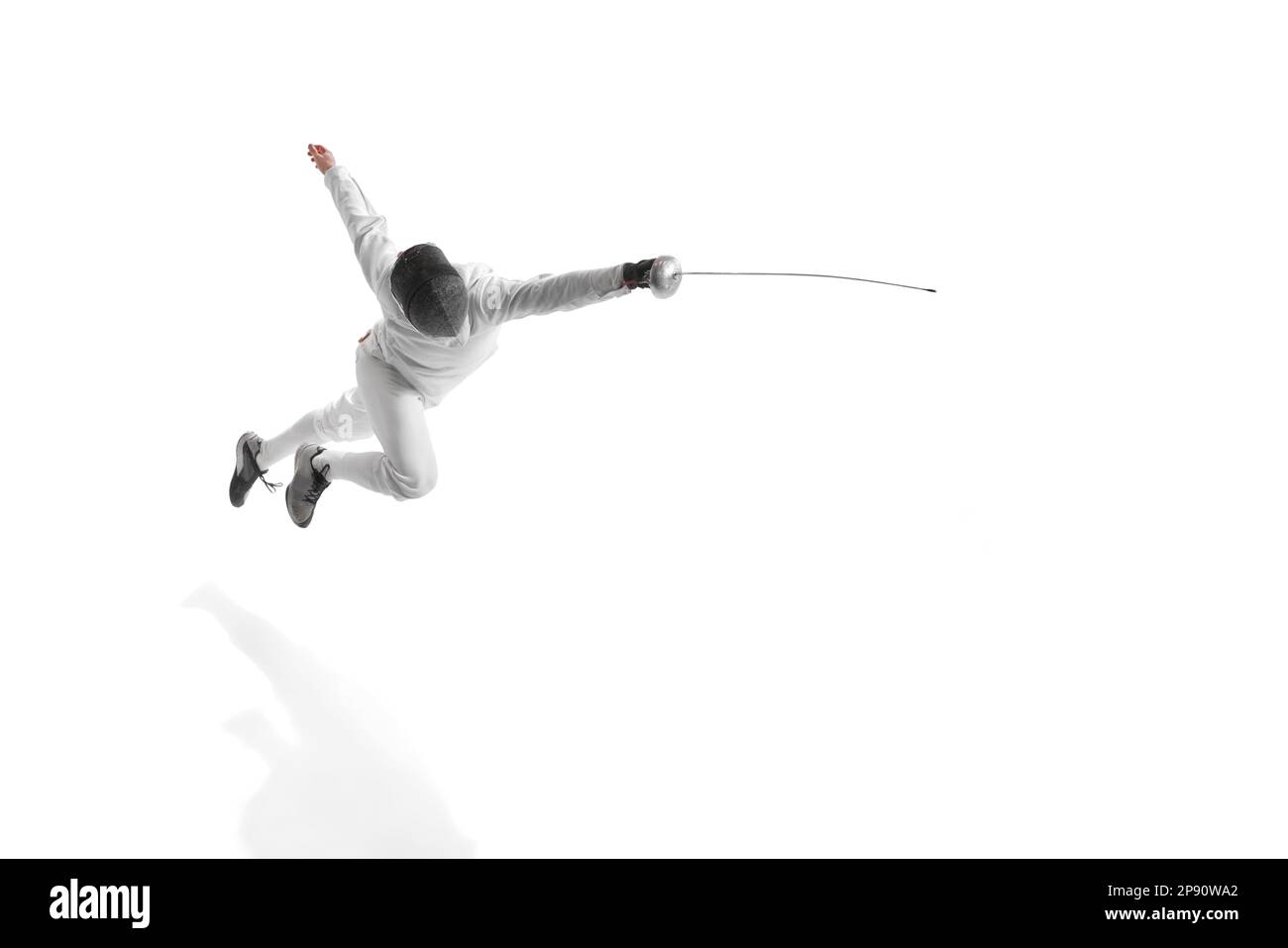 Professional male fencer in fencing costume training with sword ...