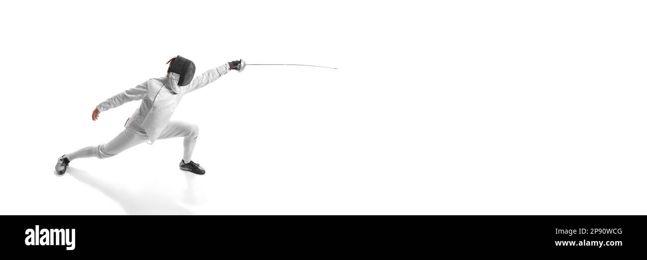 Professional male fencer in fencing costume training with sword ...