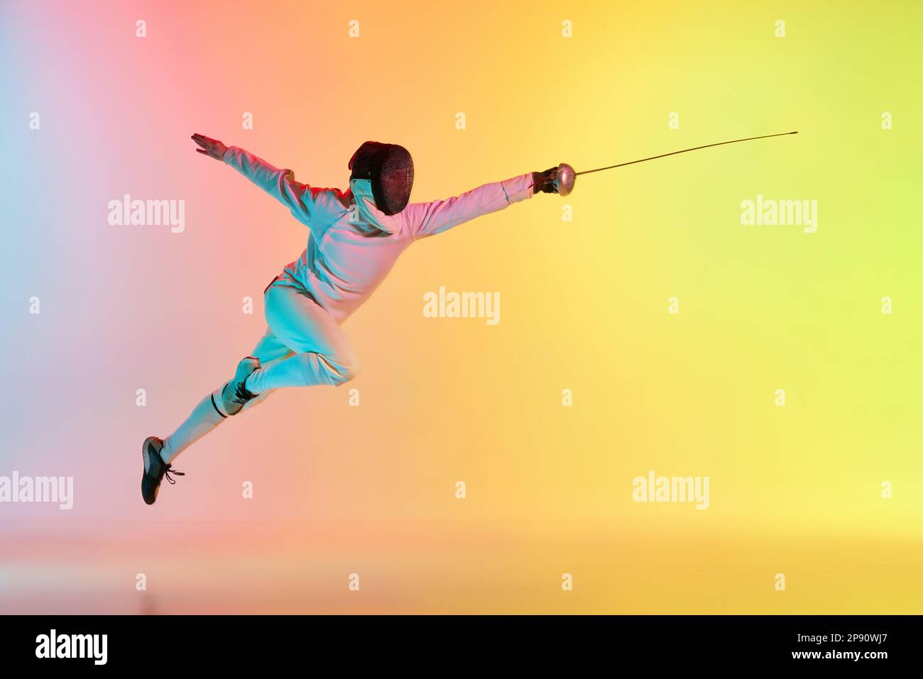 Long attack. Young man, male fencer with sword practicing in fencing ...